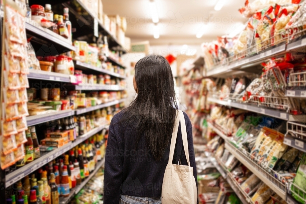 Image of 20-something Asian woman shopping buying groceries at a ...