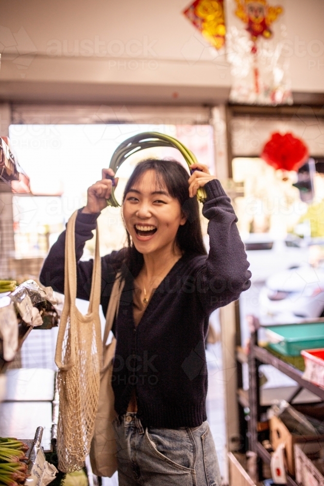 Image of 20-something Asian woman shopping buying groceries at a ...