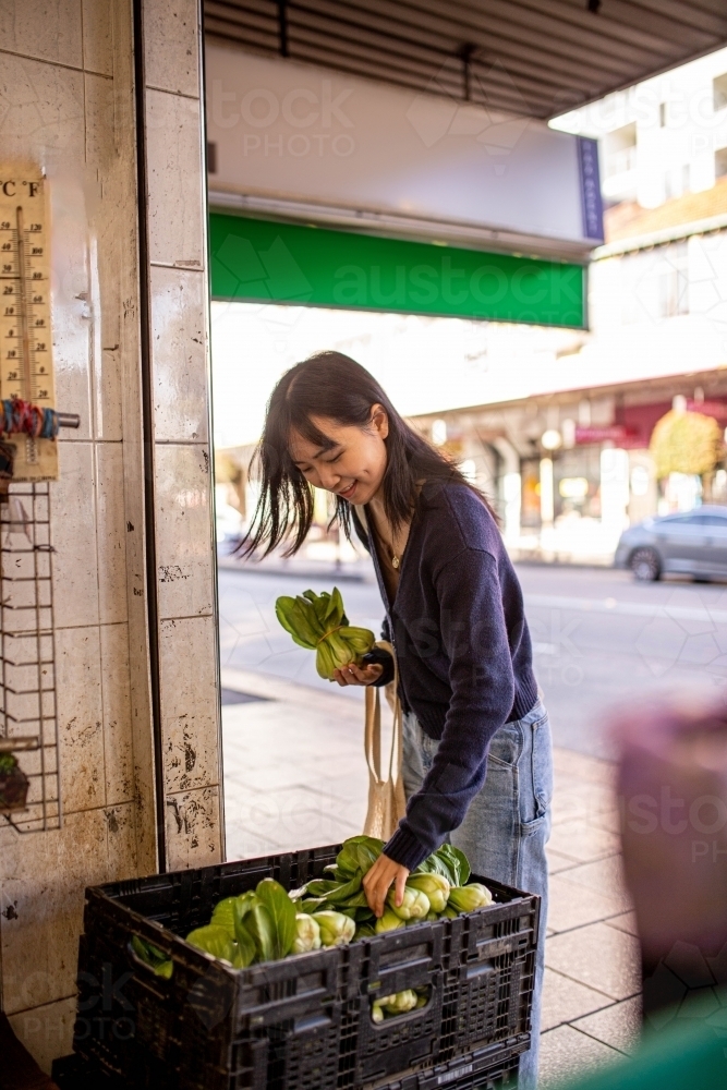 Image of 20-something Asian woman shopping buying groceries at a ...