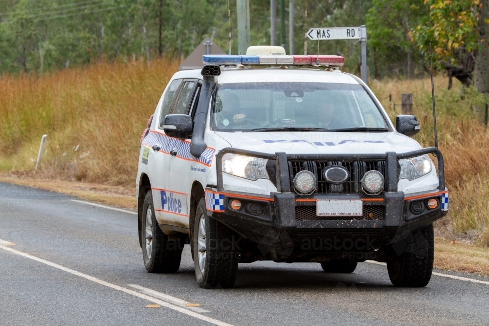 Image of 4WD police vehicle driving on rural road. - Austockphoto