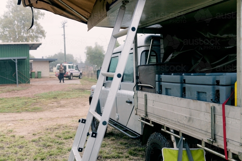 Image of 4x4 camper set up with police vehicle in the background ...