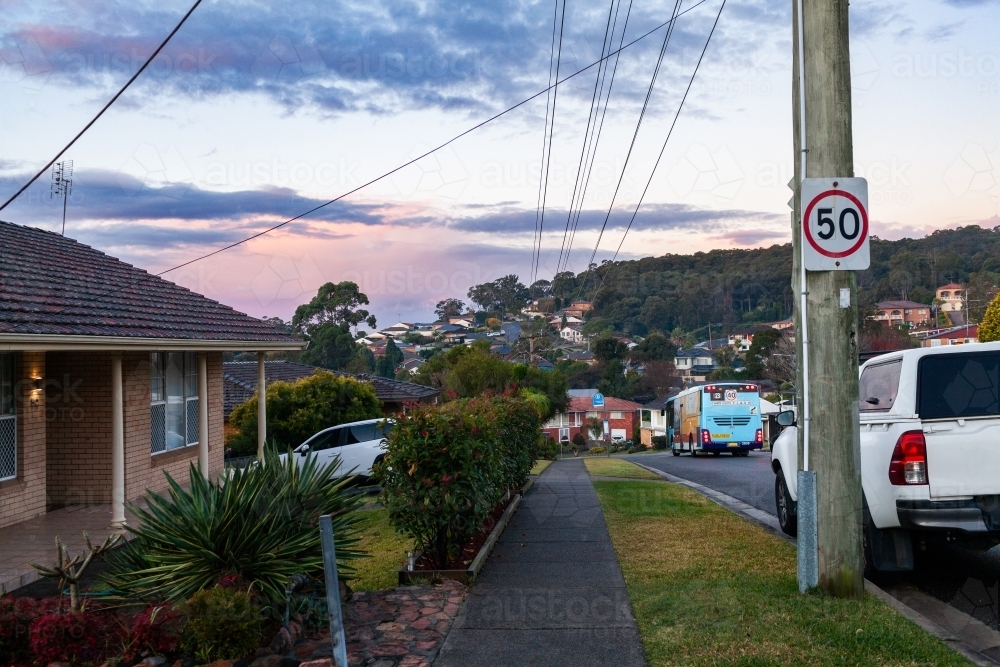 Image of 50 speed zone sign with bus stop sign on roadside and footpath ...