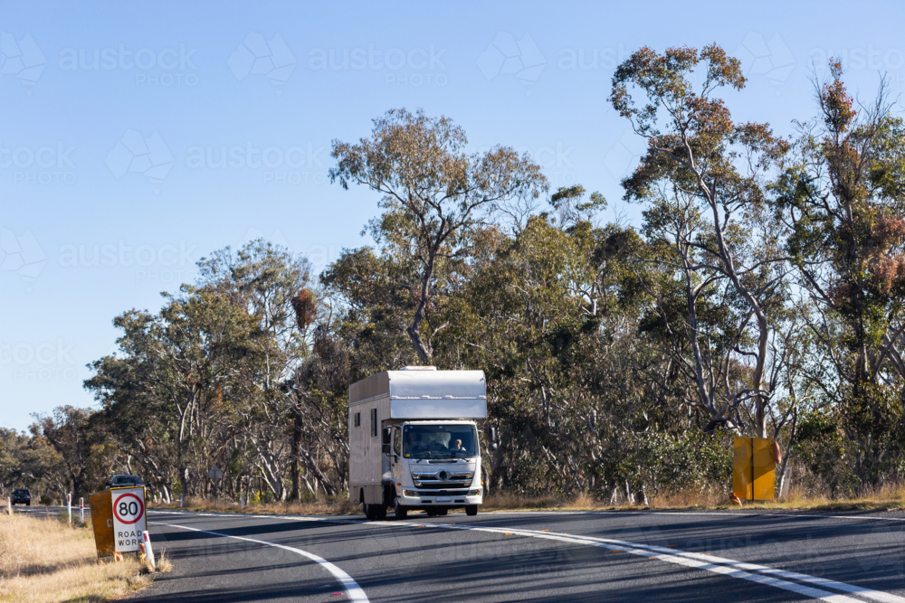 Image of 80 road work sign and vehicle driving along rural highway in ...
