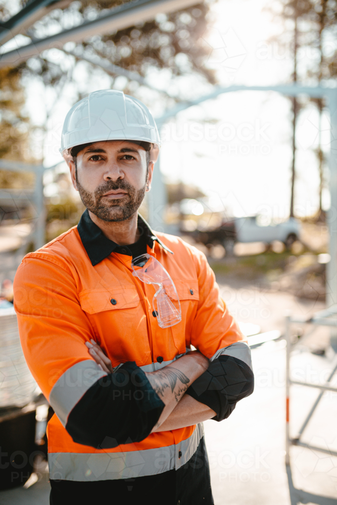 Image of A bearded contractor standing with arms crossed on ...