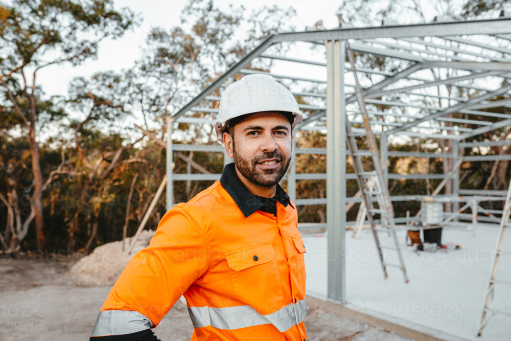Image of A bearded man standing in front of a metal structure at the ...