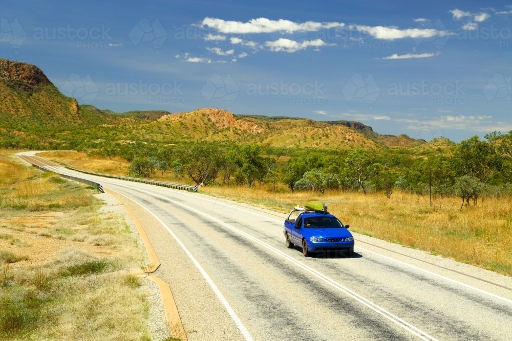 Image of A blue ute driving on the Great Northern Highway in the ...