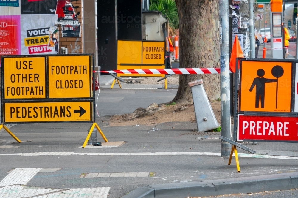 Image of A city street crowded with colourful warning signs and ...