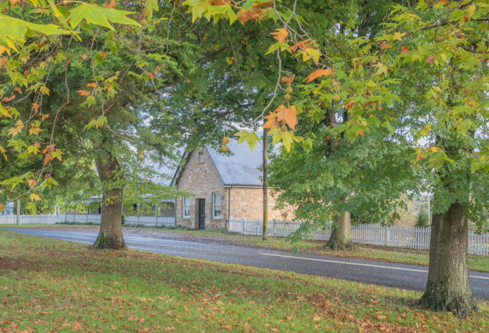 Image of A country road, an old stone house and autumn foliage ...