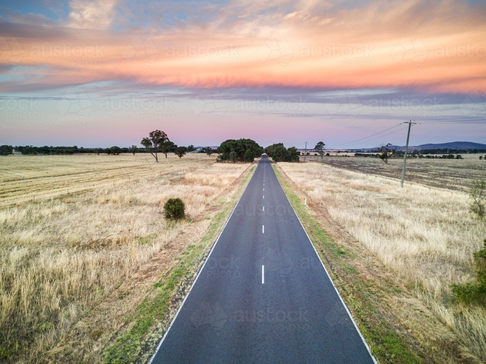 Image of A country road leads of into the distance under a bank of ...