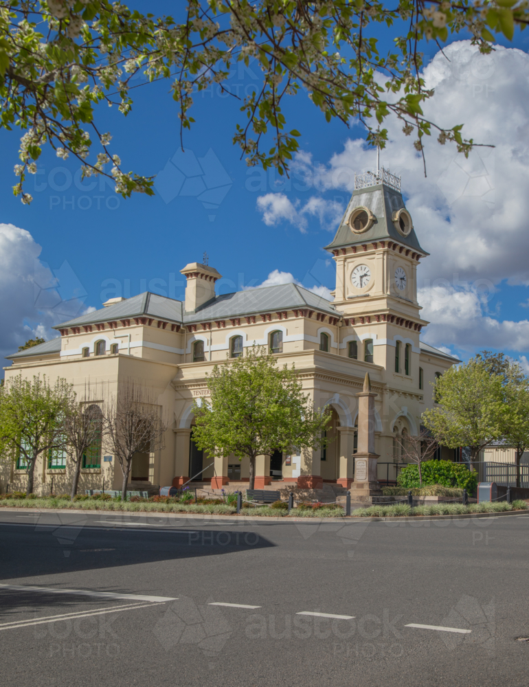 Image of A country town post office framed by green leaves underneath a ...