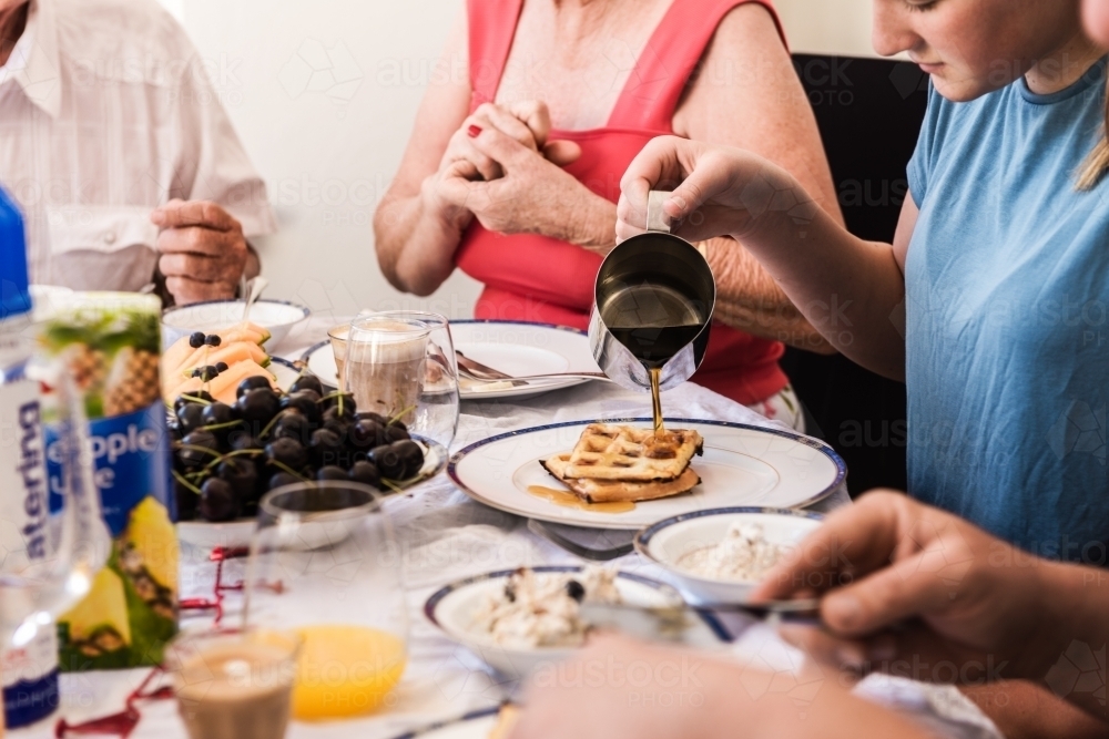 Image of a family sharing Sunday breakfast with fruit, waffles and ...
