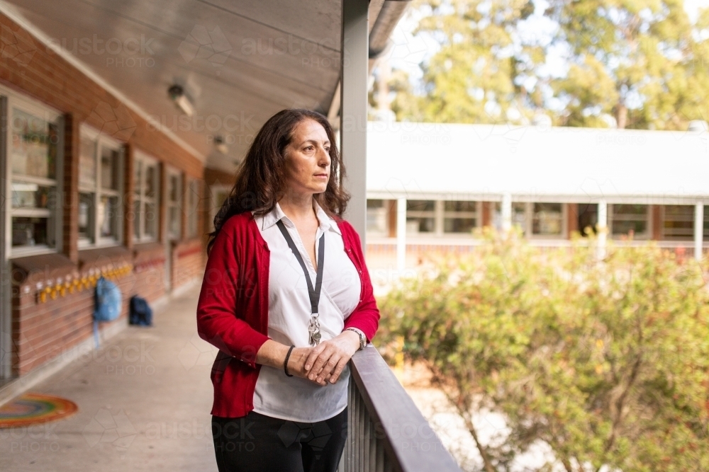 Image of A Female Teacher Standing on a School Balcony - Austockphoto