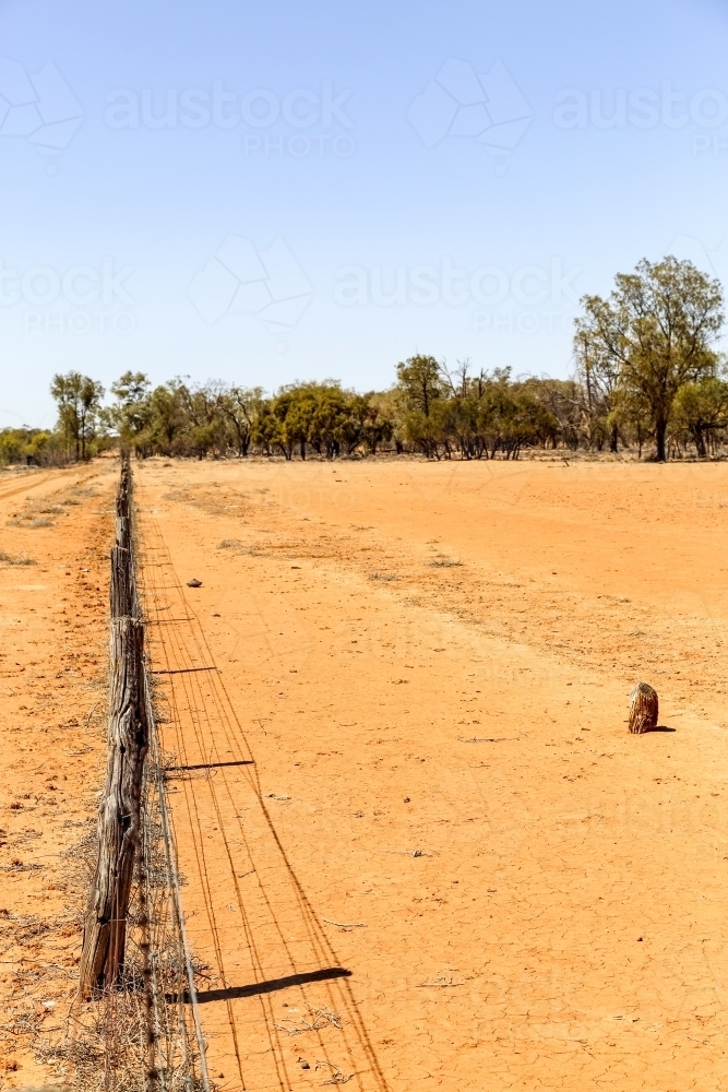 Image of A fence and dusty paddock in drought affected Queensland ...