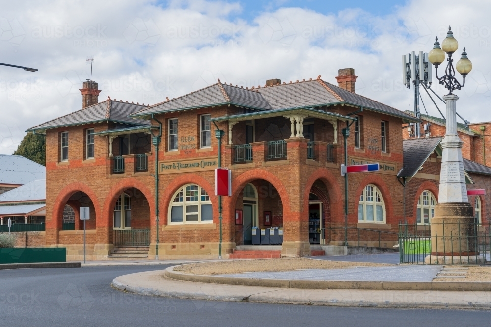 Image of A grand historic Post Office alongside a roundabout with an ...
