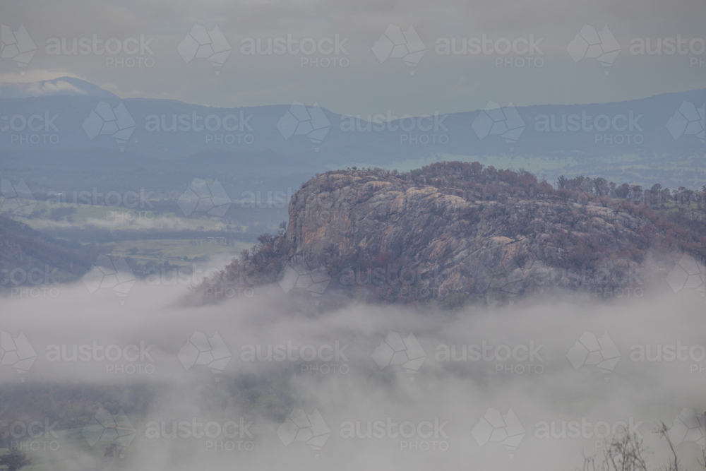 Image of A granite monolith on a misty morning in the country ...