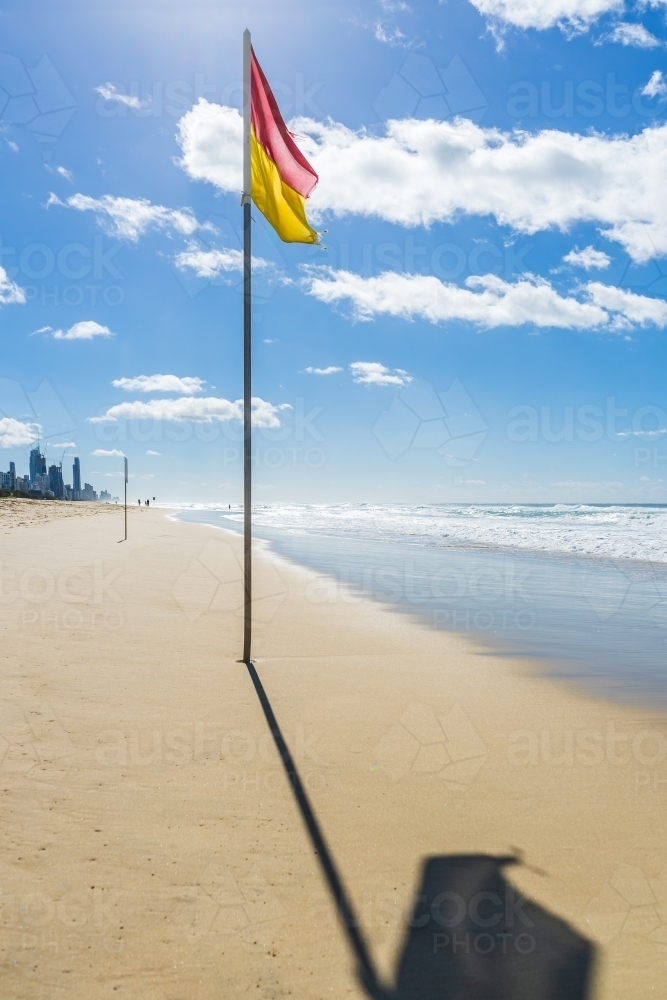 Image of A ground level view along a beach of a lifesaver's flag and ...