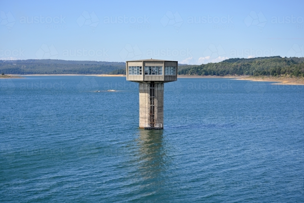 Image of A large control tower in a freshwater reservoir - Austockphoto