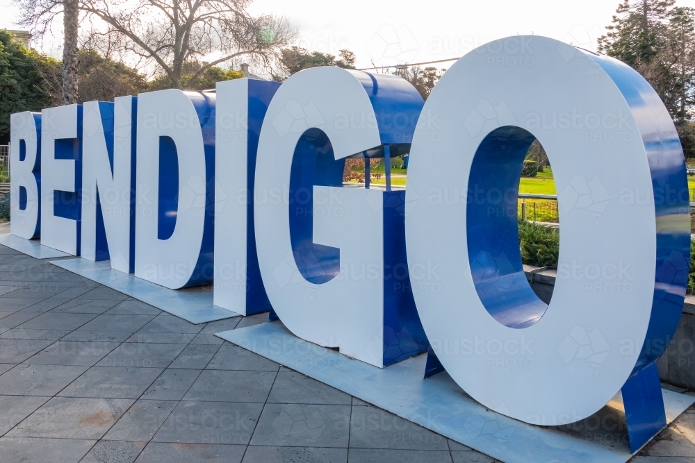 Image of A large sign made up of tall white letters sitting on a paved ...