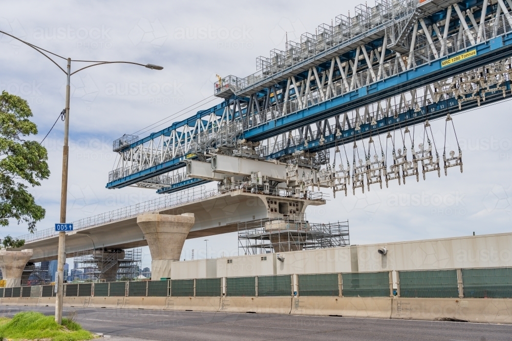 Image of a large suspension crane building an elevated freeway ...