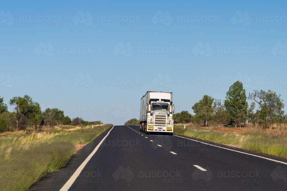 Image of A large transport truck travelling on a wide outback road ...