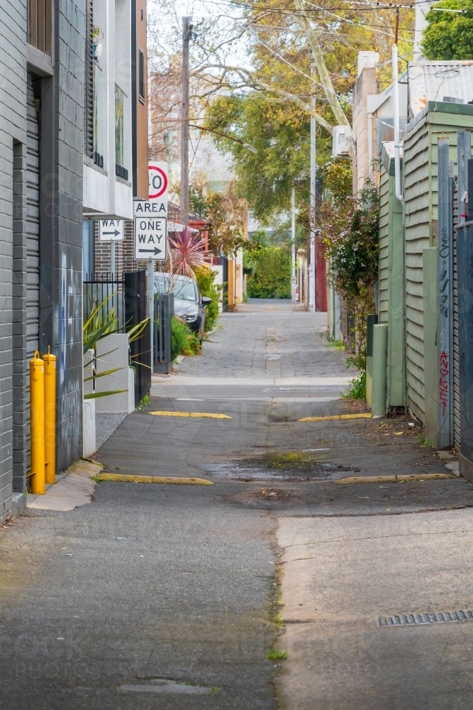 Image of A long narrow urban laneway with buildings and rear property ...