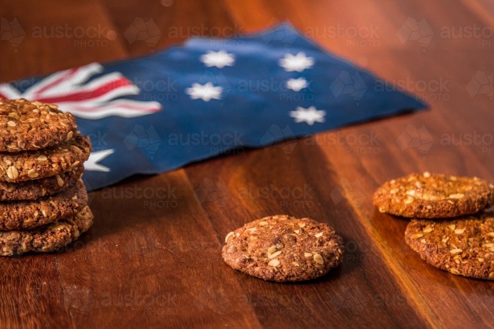 Image of A pile of ANZAC biscuits next to the Australian flag ...