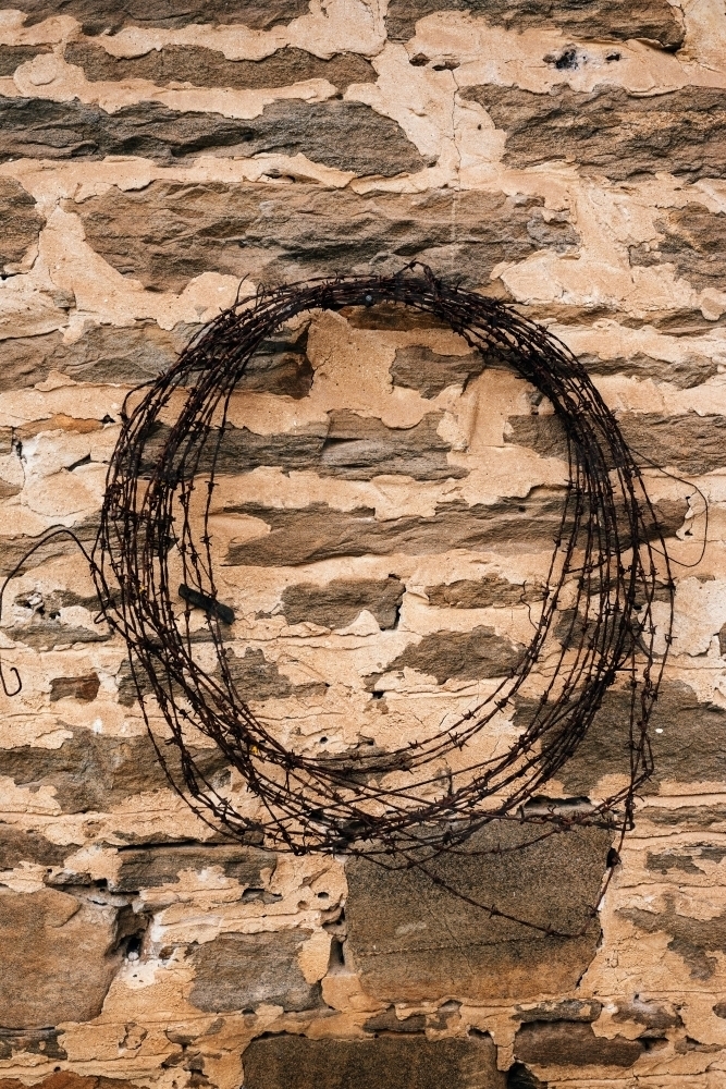 Image of a ring of old barbed wire on a farm building - Austockphoto