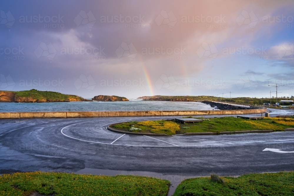 Image of A roundabout at the end of a coastal causeway with colourful ...