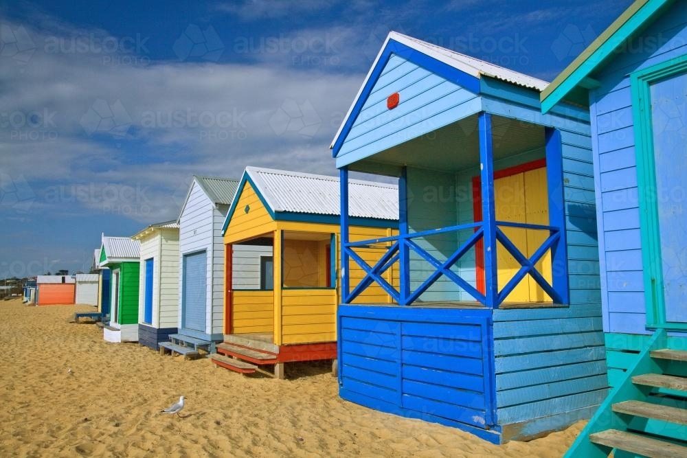 Image of A row of colourful bathing boxes - Austockphoto