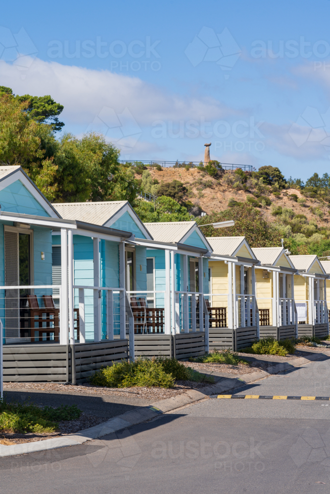 Image of A row of colourful tourist cabins in a caravan park - Austockphoto