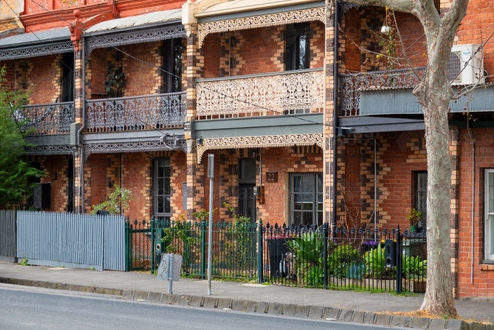 Image of A row of double storey terraces houses on a city street with ...