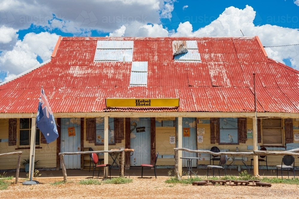 Image of A rustic outback pub with a red tin roof and wide veranda with ...