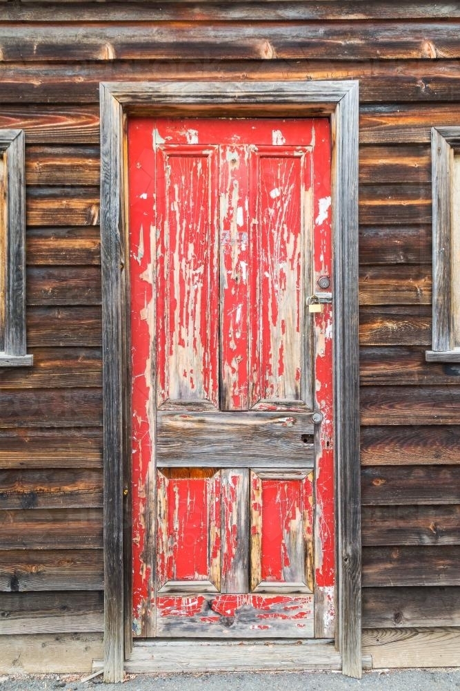 Image of A rustic red door - Austockphoto