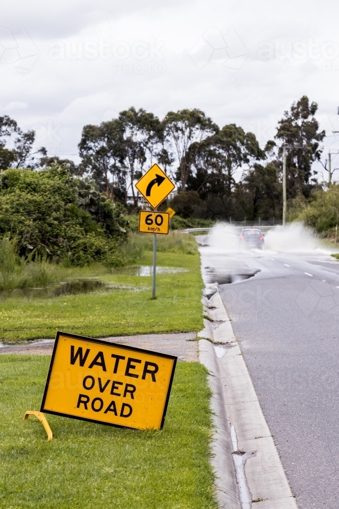 Image of A sign which says 'Water over road' warning of flash flooding ...