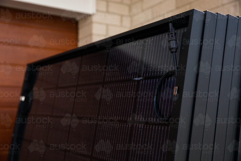 Image of a stack of solar panels ready to go on a roof - Austockphoto