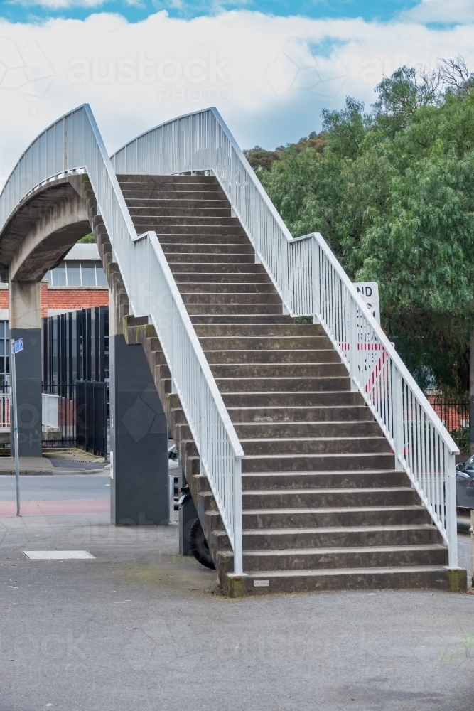 Image of A staircase with high railings leading up to a pedestrian ...