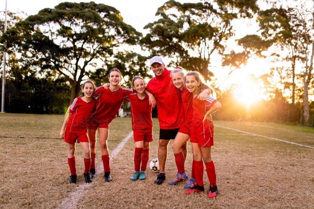 Image of A tween girls football team tmembers walking toward the camera ...