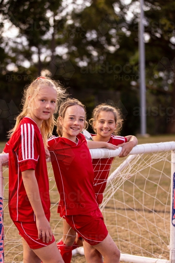 Image of A tween girls football team training together at a sports oval ...