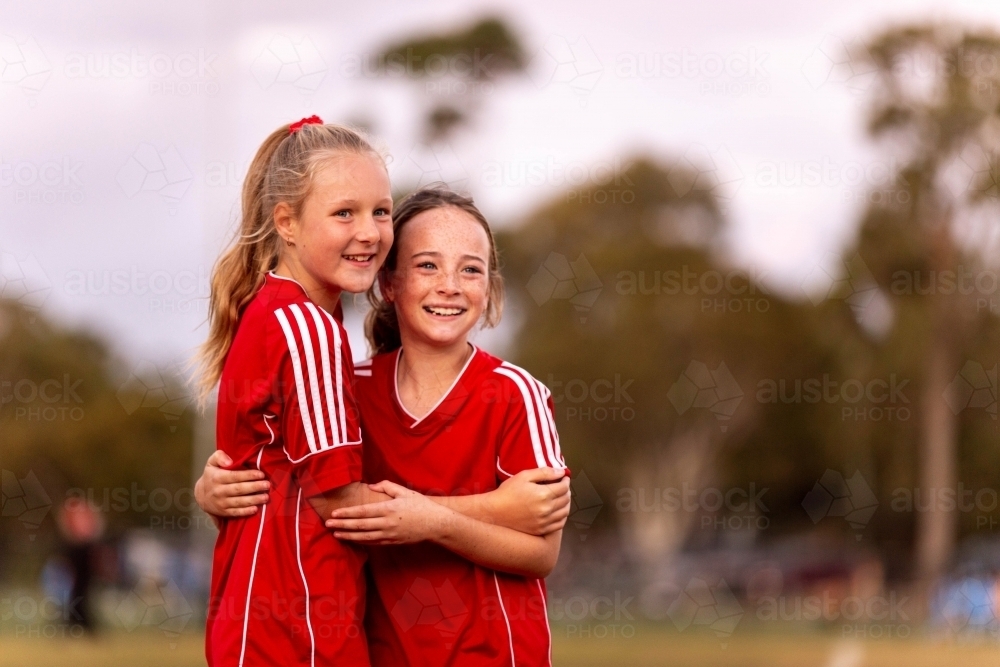 Image of A tween girls football team training together at a sports oval ...