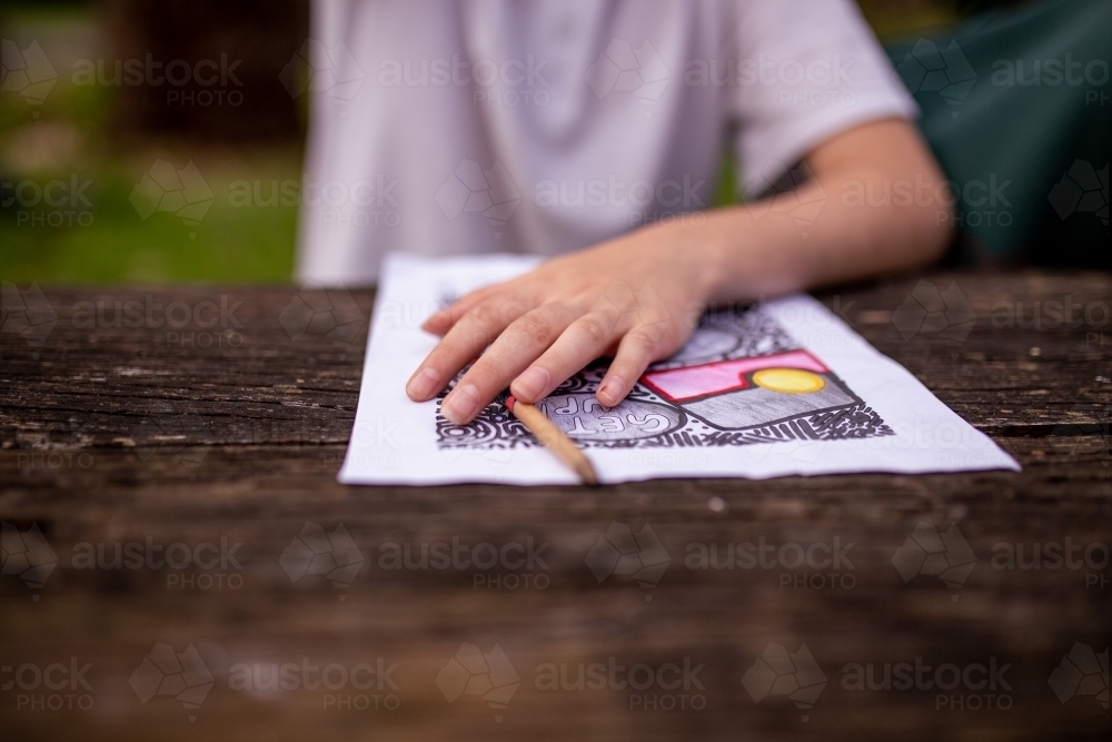 Image of A young Aboriginal girl's hand resting on a drawing of the ...