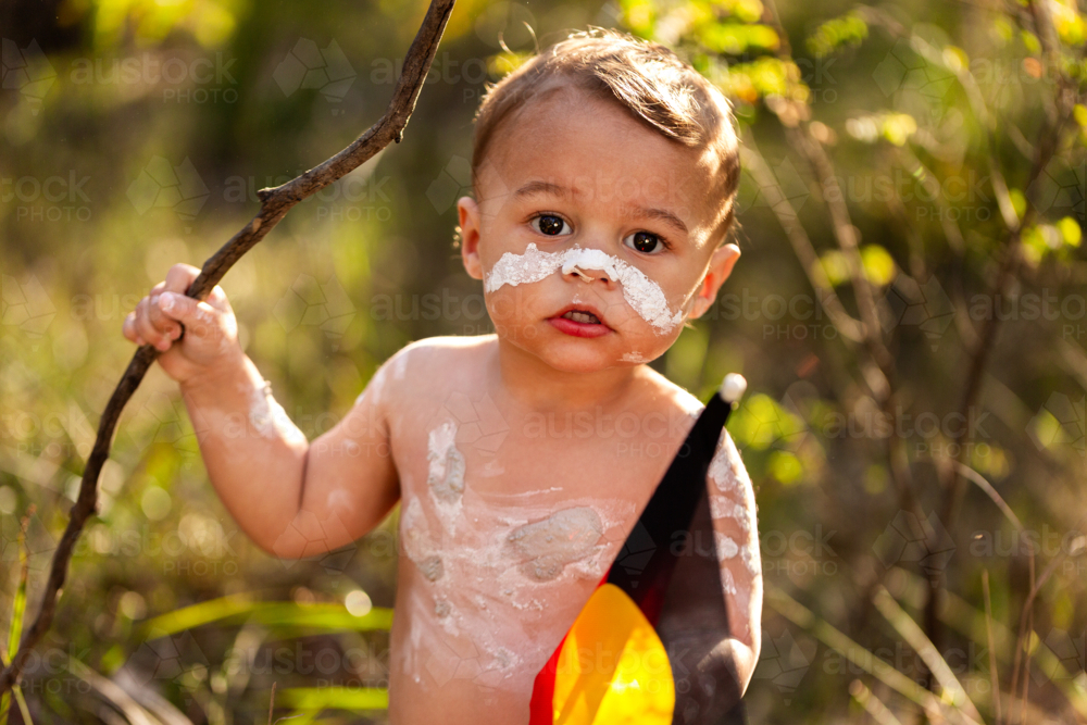 Image of Aboriginal Australian flag held in hand of toddler boy painted ...
