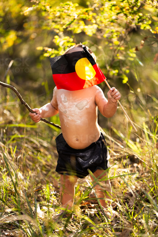Image of Aboriginal Australian flag held in hand of toddler boy painted ...