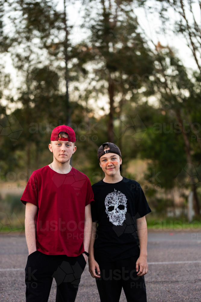 Image of Aboriginal Australian teenaged cousins standing beside road ...