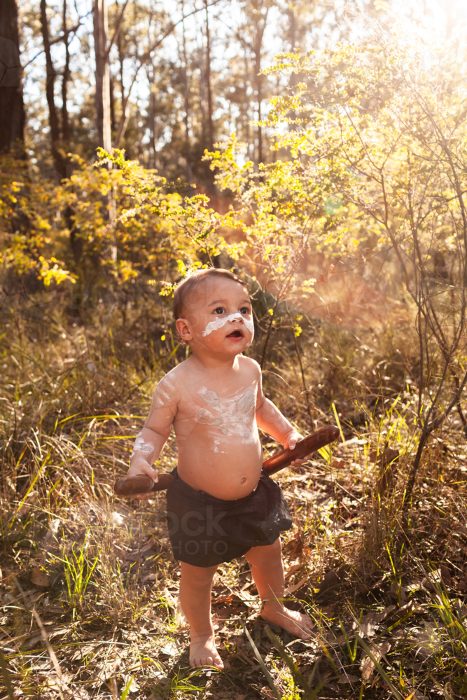 Image of Aboriginal Australian toddler boy painted in ochre in green ...