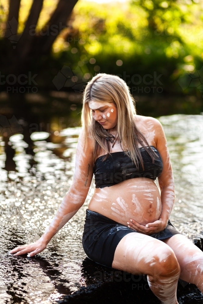 Image Of Aboriginal Australian Woman Touching Running Water In Creek
