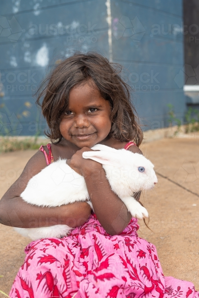 Image of Aboriginal child with pet rabbit - Austockphoto