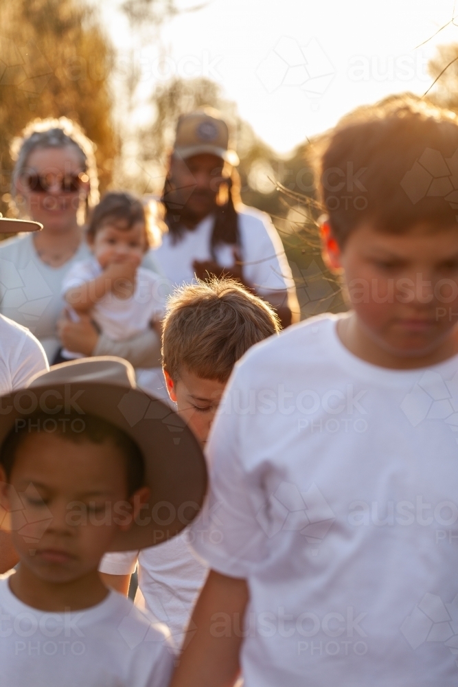 Image of Aboriginal family walking together through bushland - Austockphoto