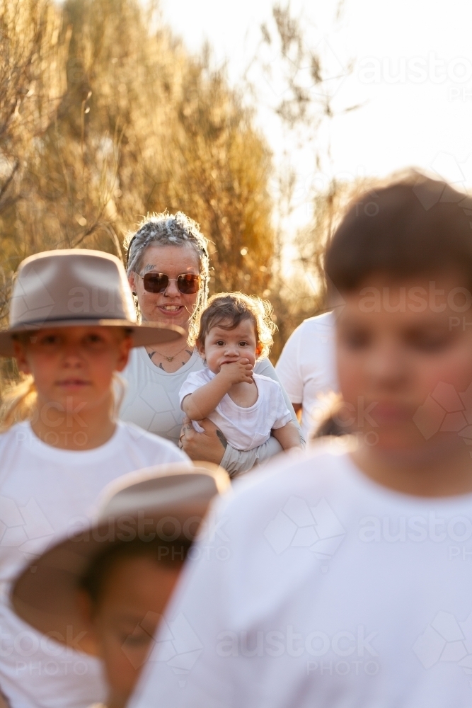 Image of Aboriginal family walking together through bushland - Austockphoto