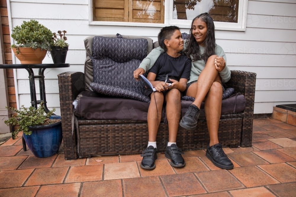 Image of Aboriginal girl and young Aboriginal boy sitting together ...