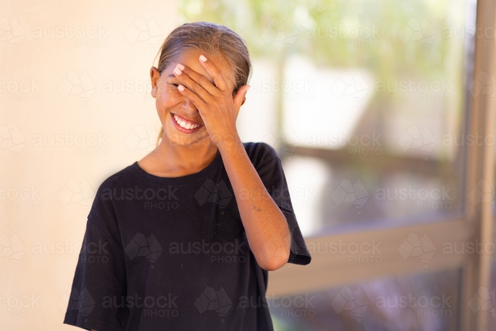 Image of aboriginal girl child face palming in black tee shirt with ...